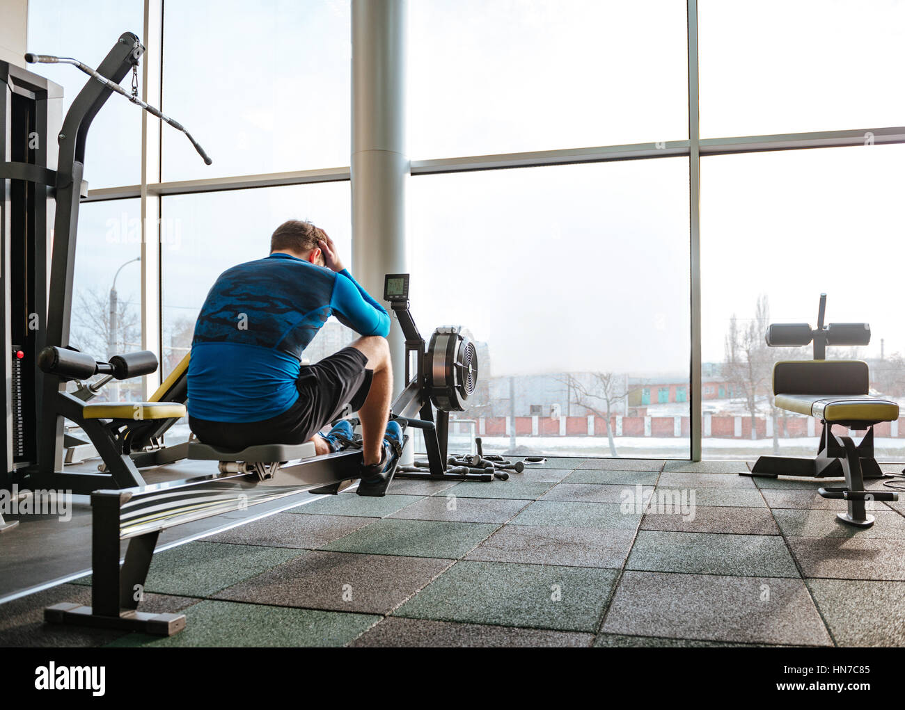 Back view image of attractive young sportsman in gym make sport ...