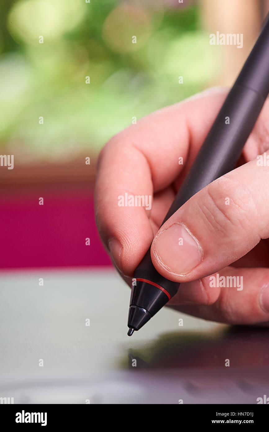 close up designer tablet pen in hand making sketch Stock Photo - Alamy