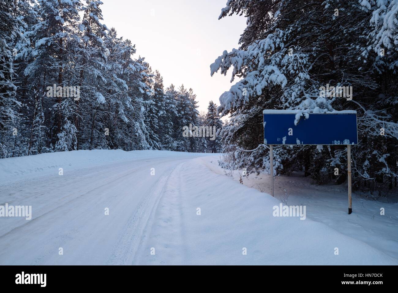 Winter road landscape with traffic sign Stock Photo - Alamy