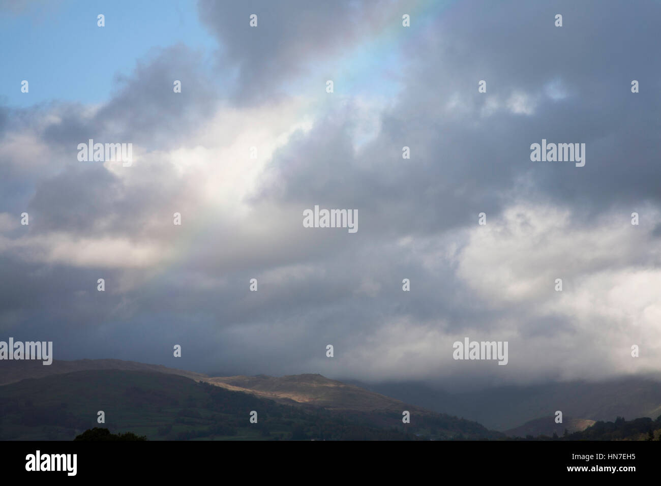 Storm clouds and rainbow passing over Windermere the Lake District ...