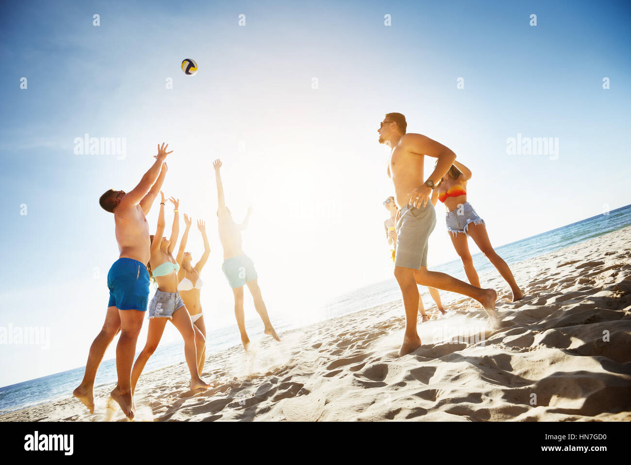 Group friends plays ball beach sea Stock Photo - Alamy