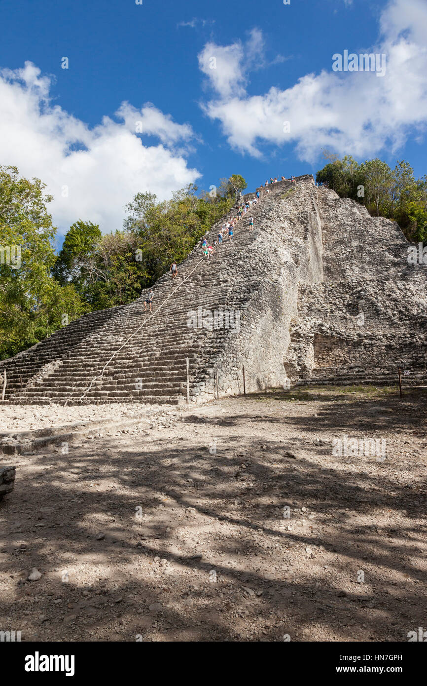 Tourist climbing Nohoch Mul the temple pyramid, Coba, Ancient Mayan ...