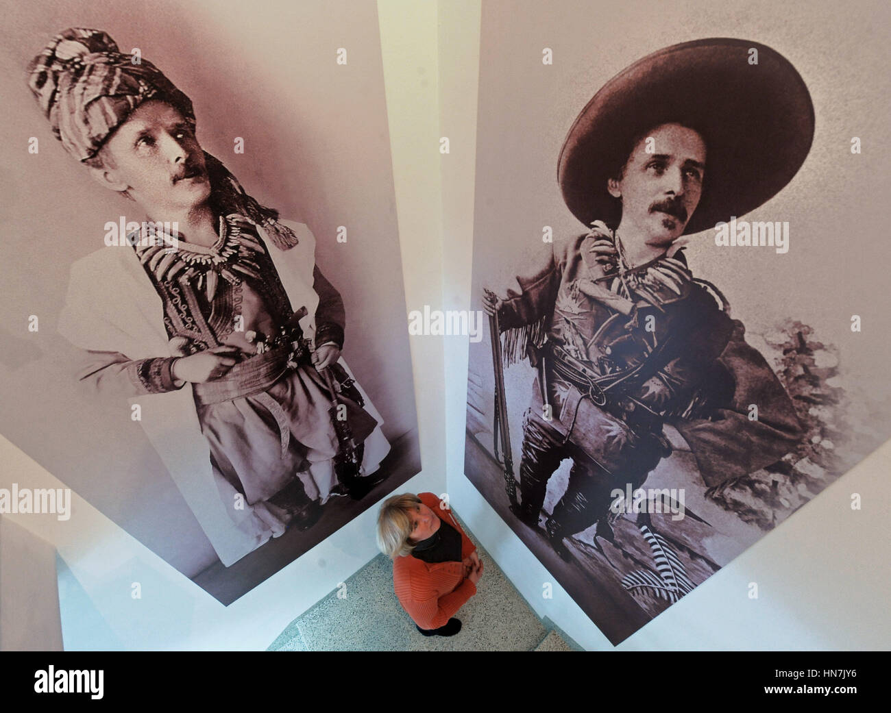 A woman looks at two oversized photos showing author Karl May in ...
