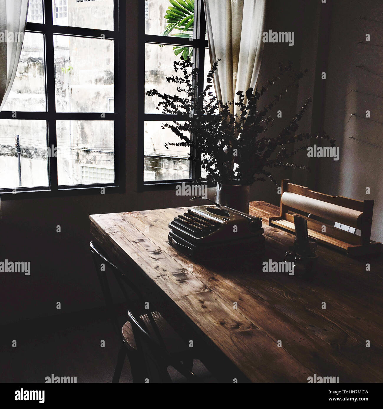 Dark room with table and typewriter Stock Photo - Alamy