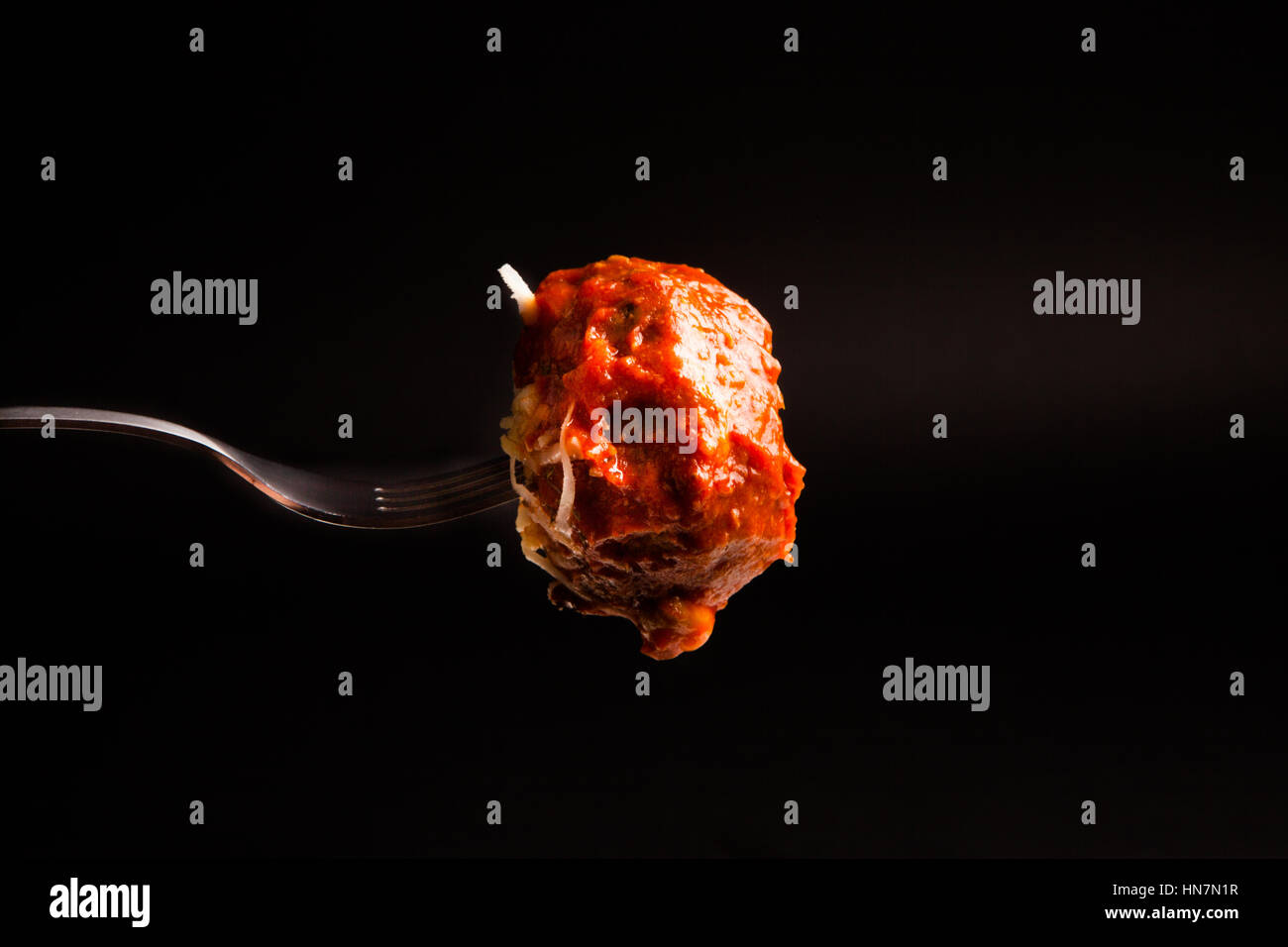 Meat ball on a fork black background still mage food photography Stock ...