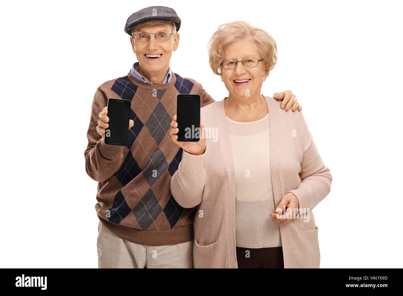 Cheerful seniors showing phones to the camera isolated on white ...