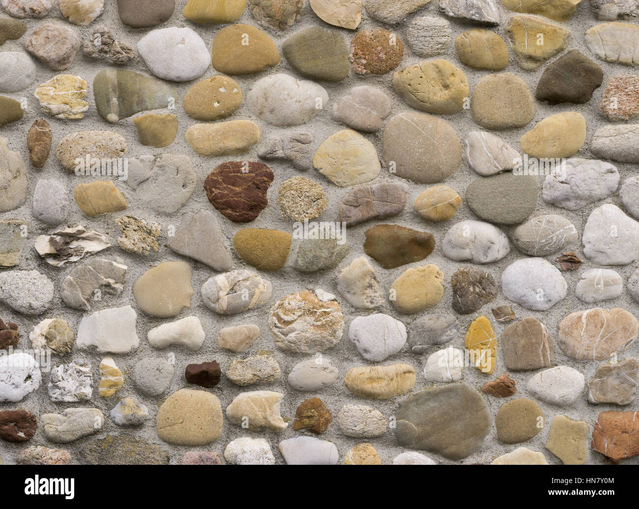 Rock wall of natural river stones Stock Photo - Alamy