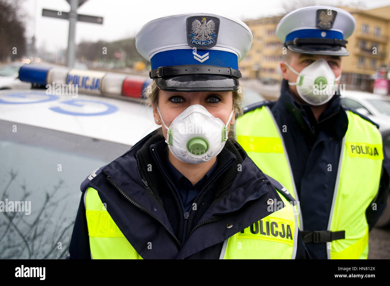 Krakow, Poland. 08th Feb, 2017. The police wear masks due to a heavy ...