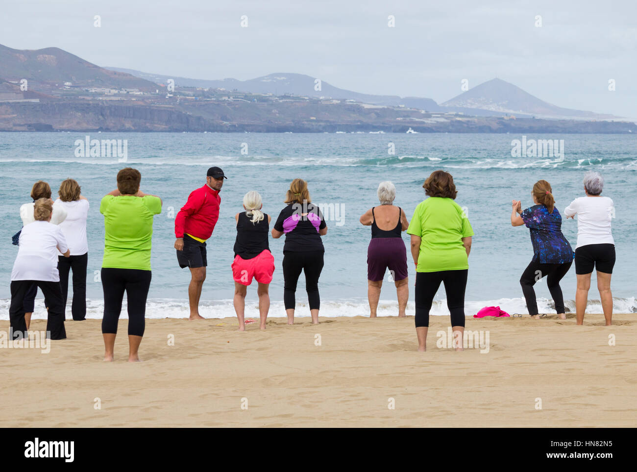 Pensioners keep fit class on beach in Spain Stock Photo - Alamy