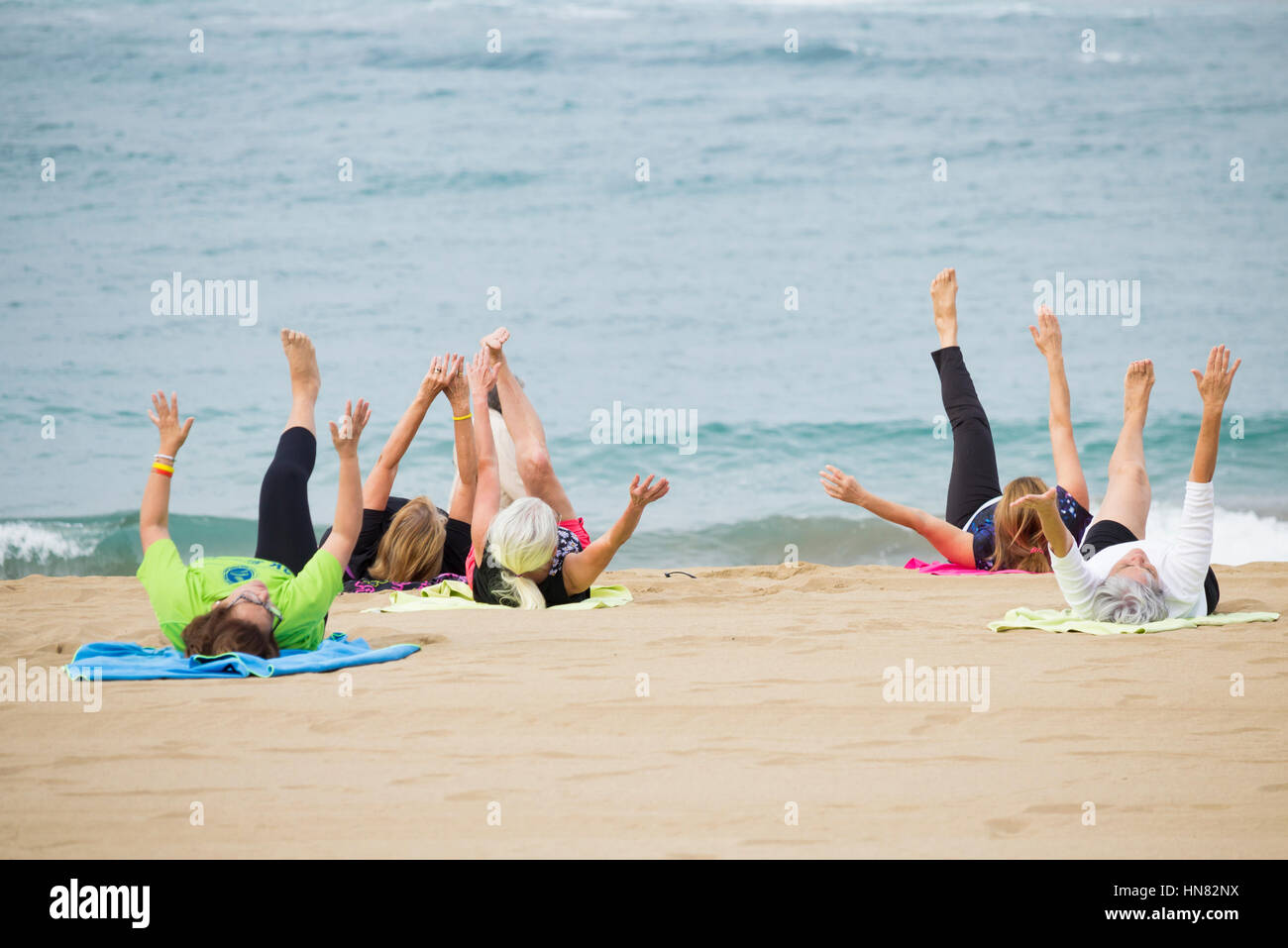Pensioners keep fit class on beach in Spain Stock Photo - Alamy