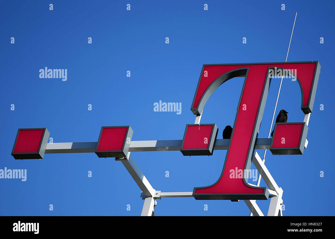 Crows sitting on a Deutsche Telekom logo on the company's headquarters ...