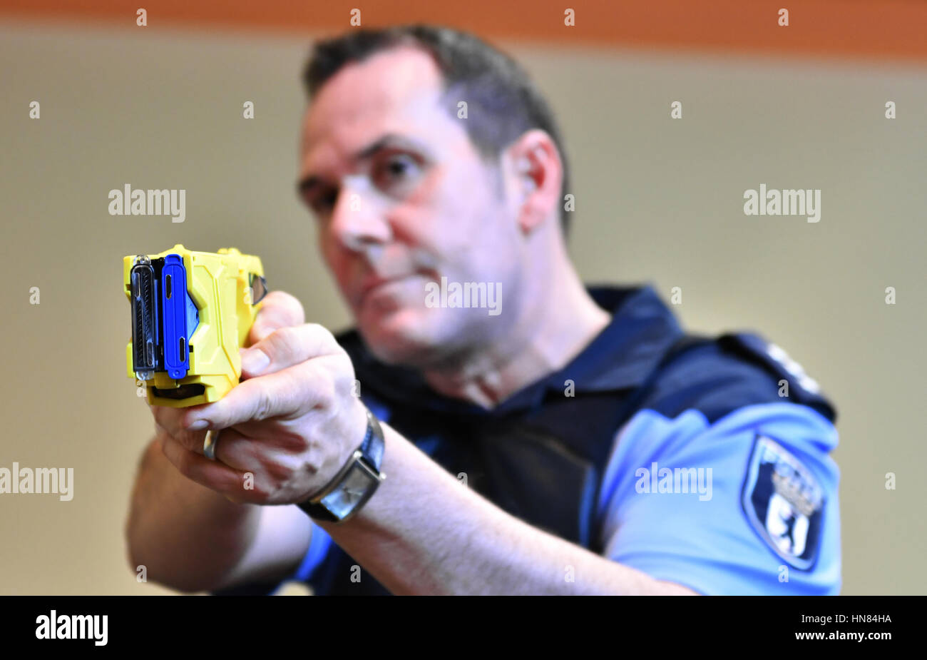 Berlin, Germany. 09th Feb, 2017. A police officer demonstrates the use ...
