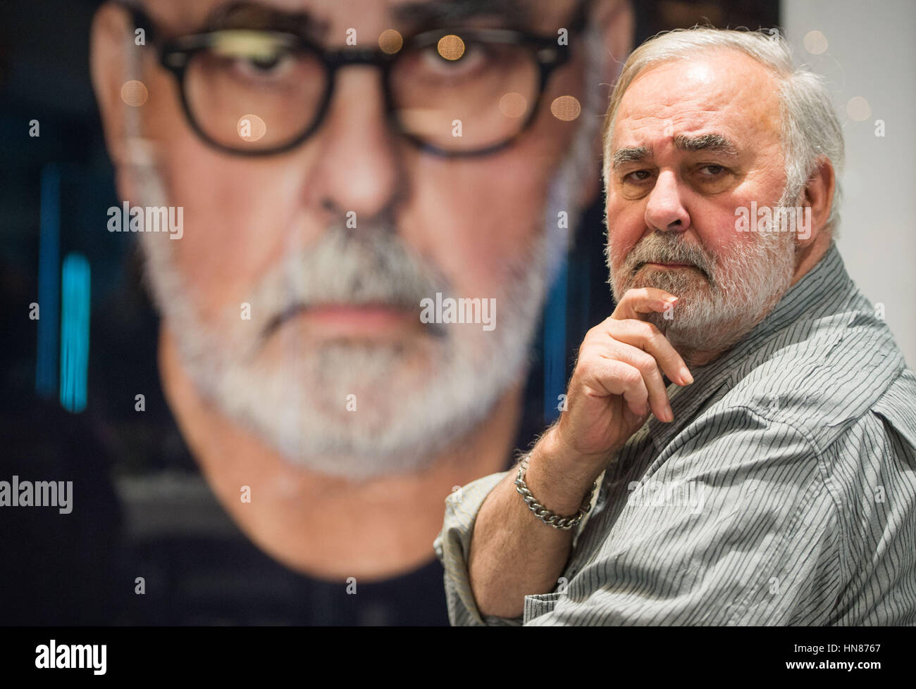 Hair stylist Udo Walz seen in front of a portrait of himself in his ...