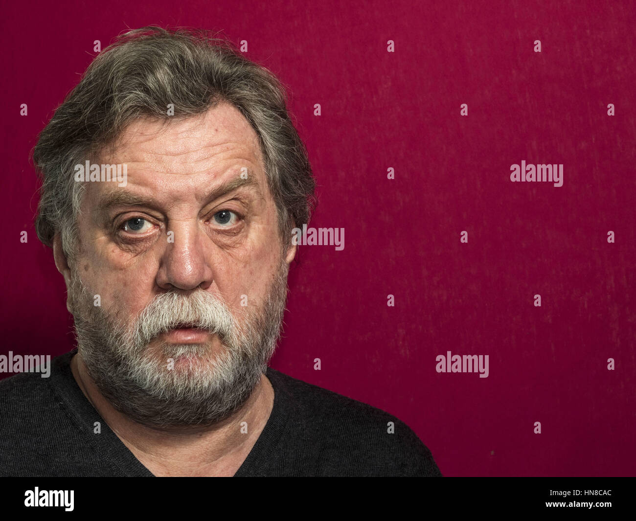 February 10, 2017 - Portrait Of mddle aged caucasian Man on red ...