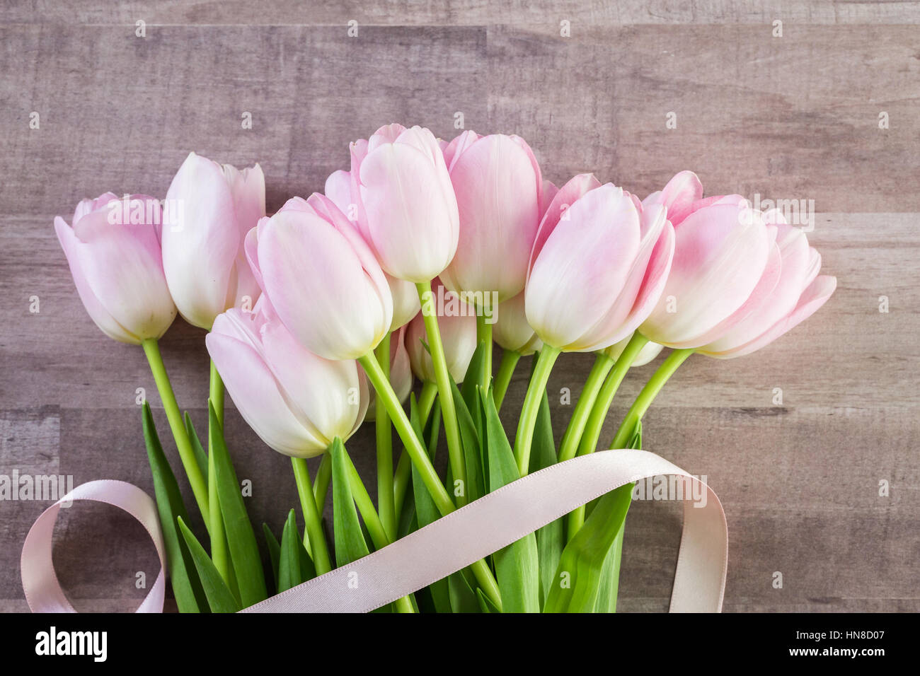 Bouquet of pink tulips on a wood background Stock Photo - Alamy