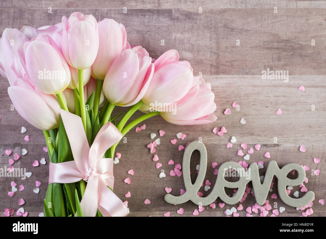 Bouquet of pink tulips on a wood background Stock Photo - Alamy