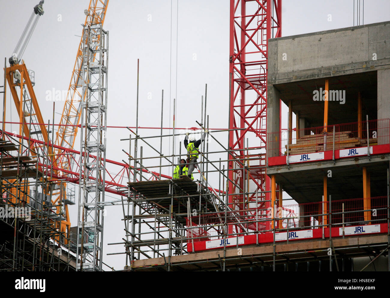 Builders work on a construction site, part of the Wandsworth Town ...
