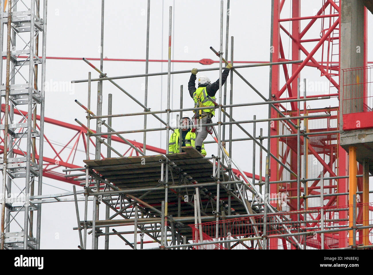 Builders work on a construction site, part of the Wandsworth Town ...