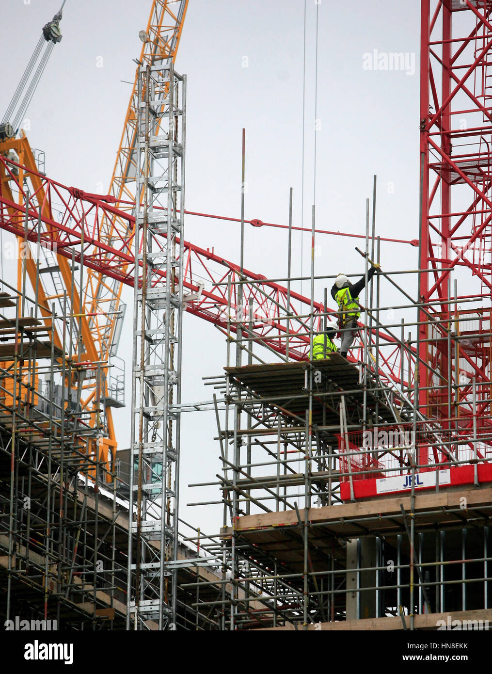 Builders work on a construction site, part of the Wandsworth Town ...
