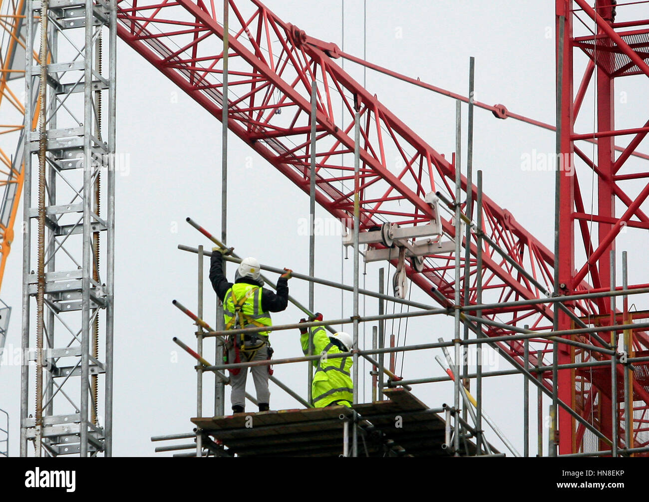 Builders work on a construction site, part of the Wandsworth Town ...