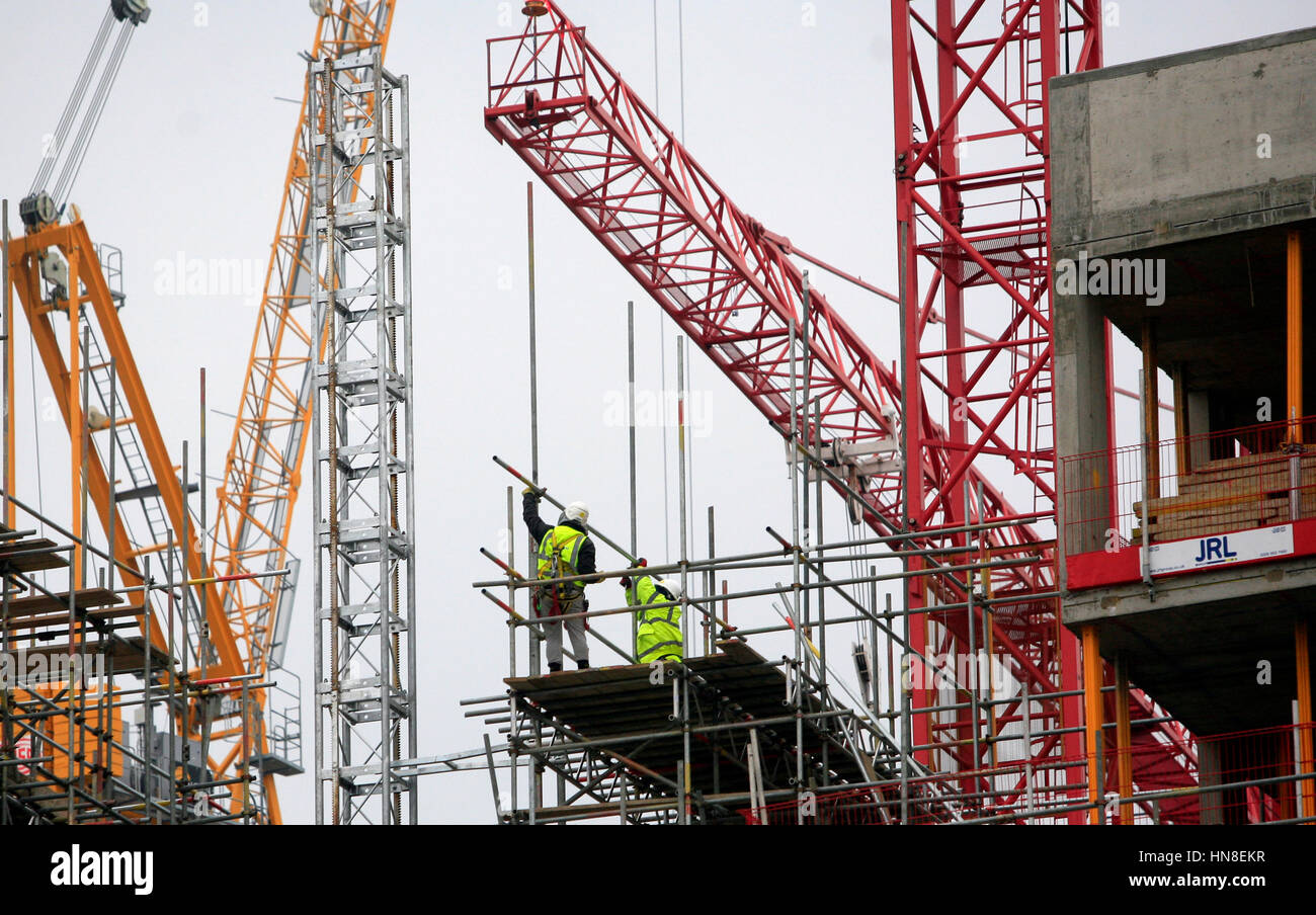 Builders work on a construction site, part of the Wandsworth Town ...