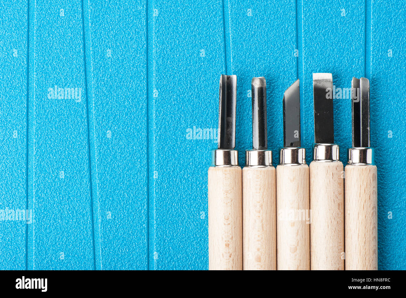 Set of new chisels isolated on blue background Stock Photo - Alamy