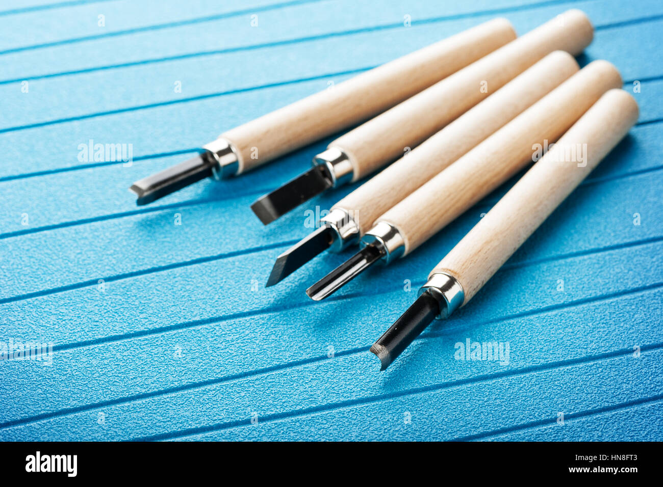 Set of new chisels isolated on blue background Stock Photo - Alamy