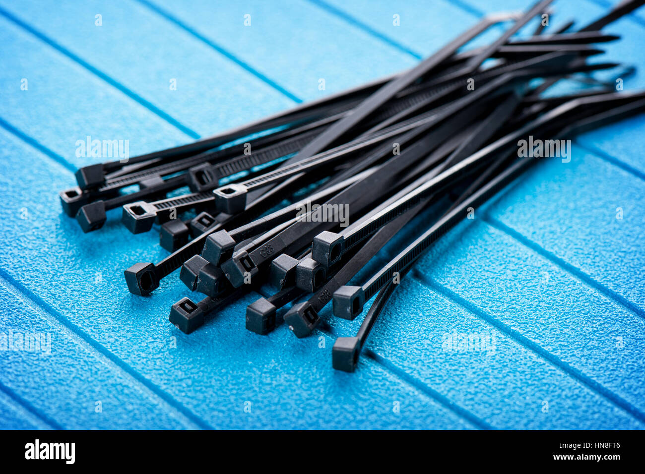 heap of colorful cable ties on blue background Stock Photo - Alamy