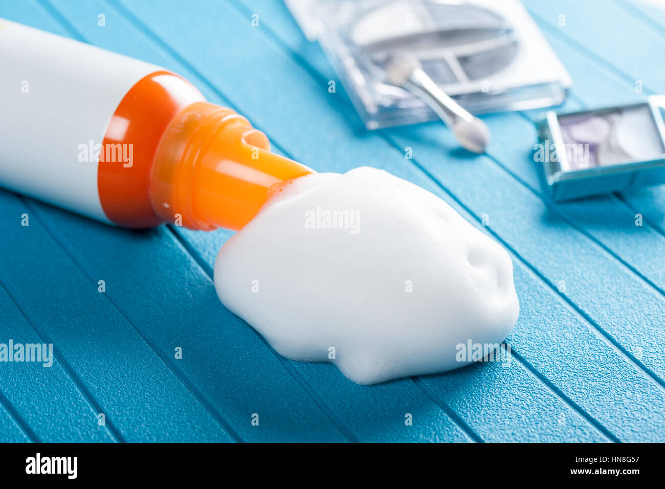 closeup white hair mousse on blue background Stock Photo - Alamy