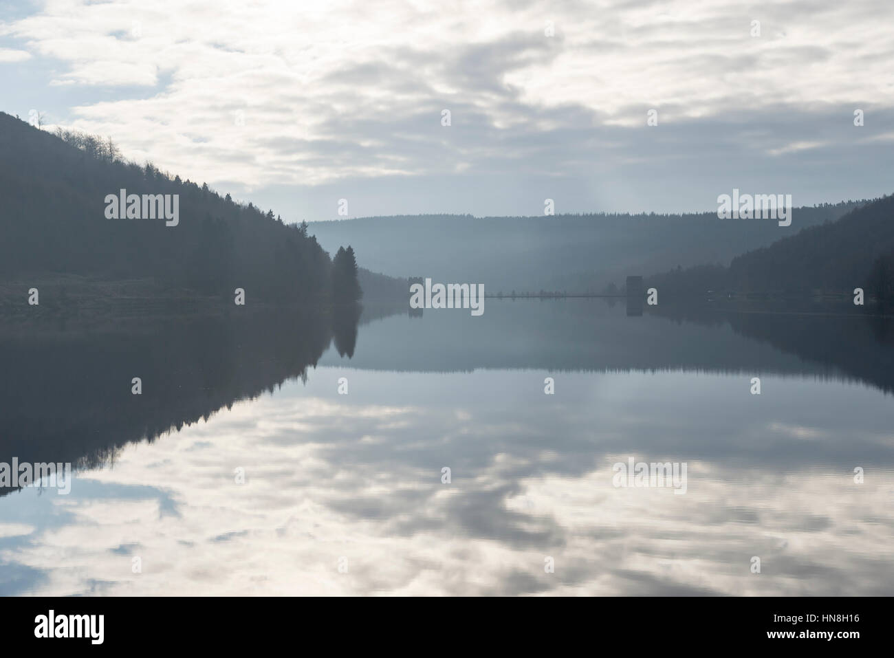 View over still water to Derwent dam in the Upper Derwent valley ...