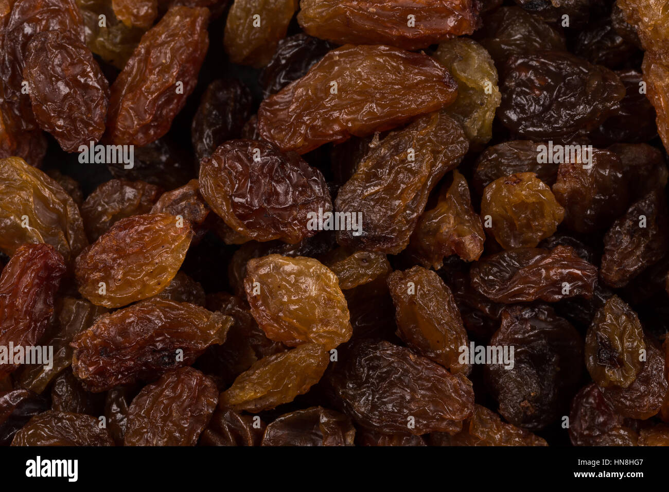 Sweet dry raisins close up shot for background Stock Photo - Alamy