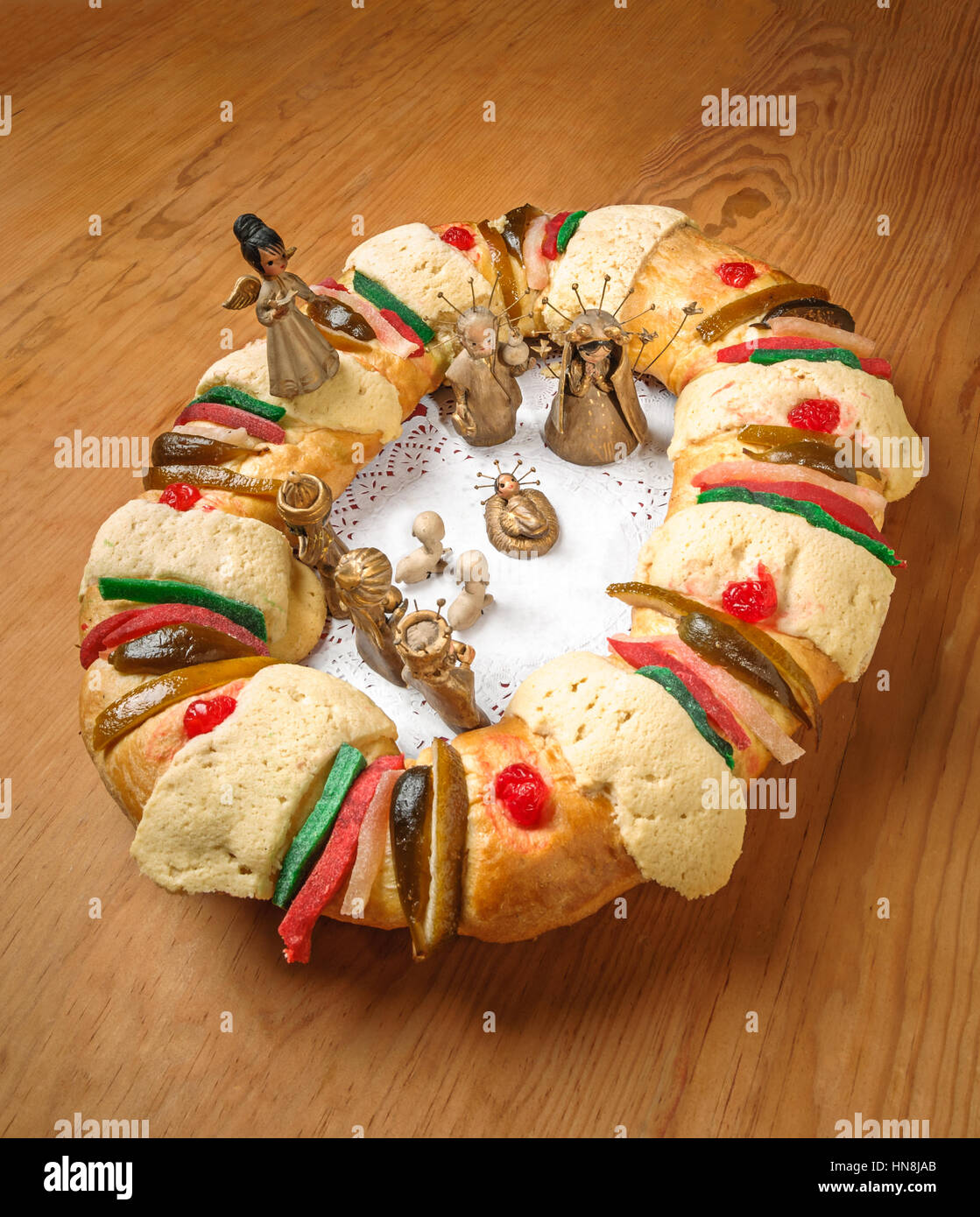 Epiphany Cake, kings cake, or Rosca de reyes with manger on wooden ...
