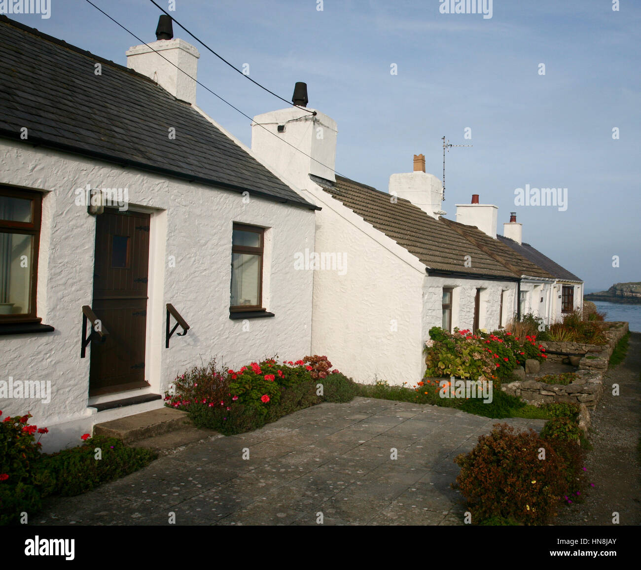 Pretty White cottages at Moelffre on the coast of Anglesey, North Wales ...