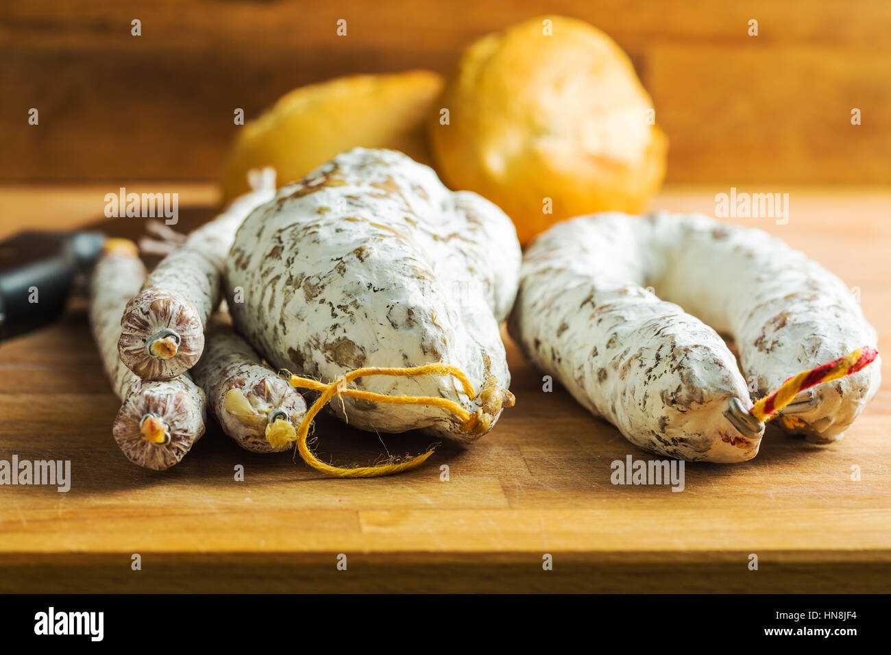 Tasty salami with white mold on kitchen table Stock Photo - Alamy