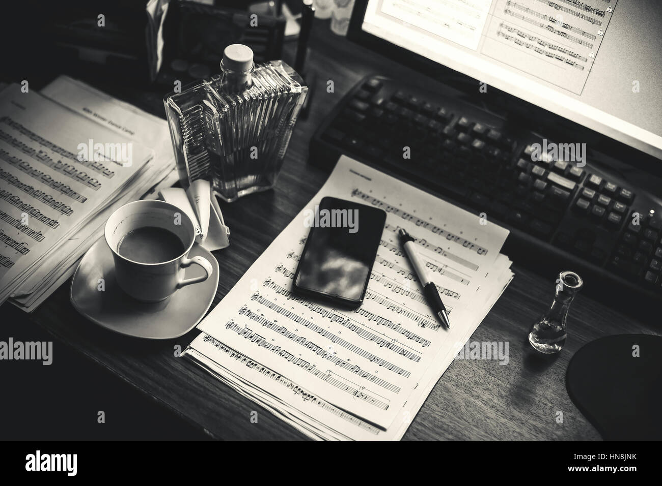 Details of a table of a composer, music note sheets and computer and ...