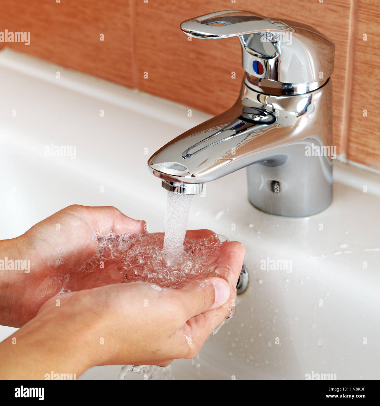 Washing hand under tap water Stock Photo - Alamy