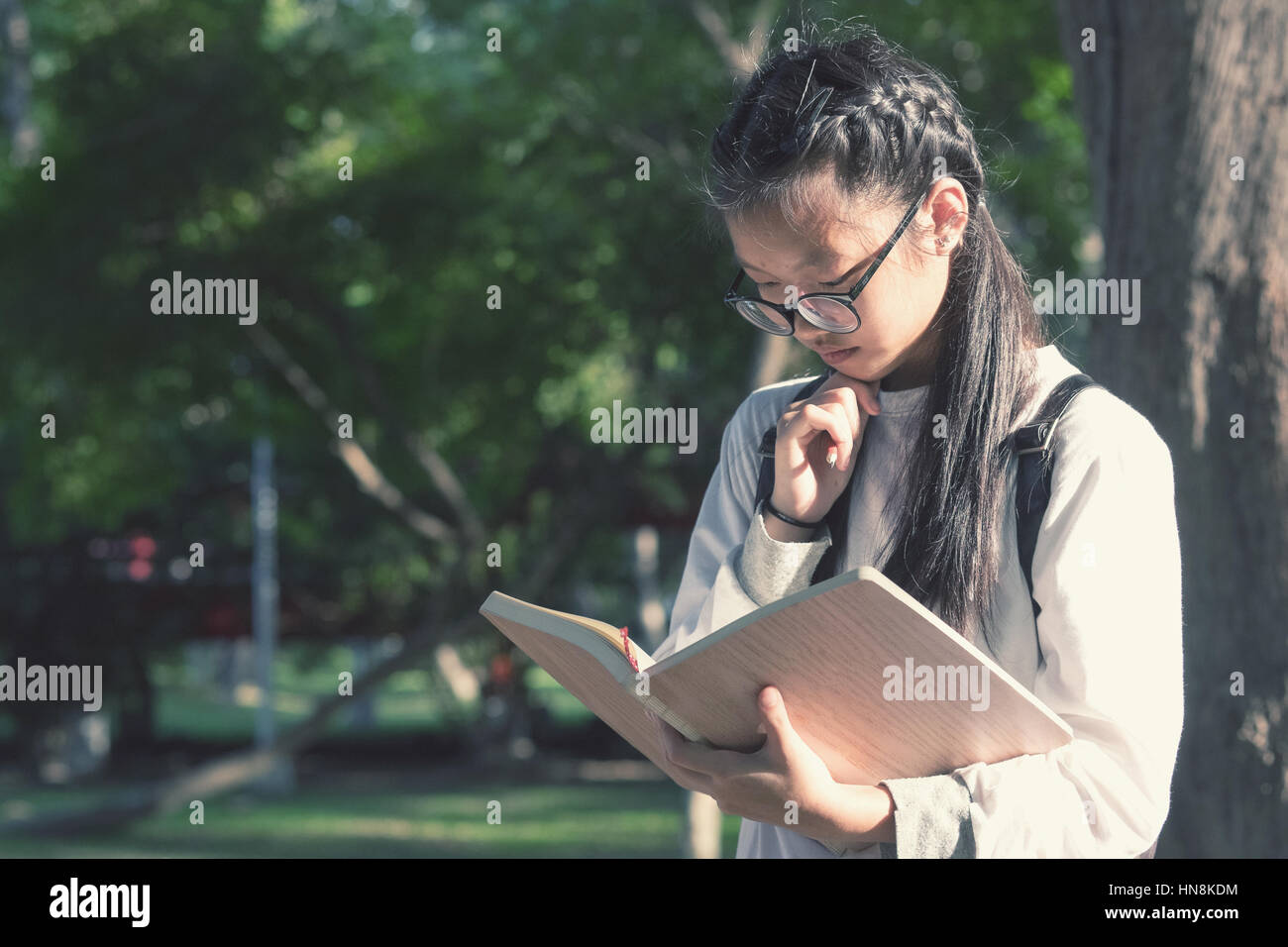 Girl reading open book in hi-res stock photography and images - Alamy