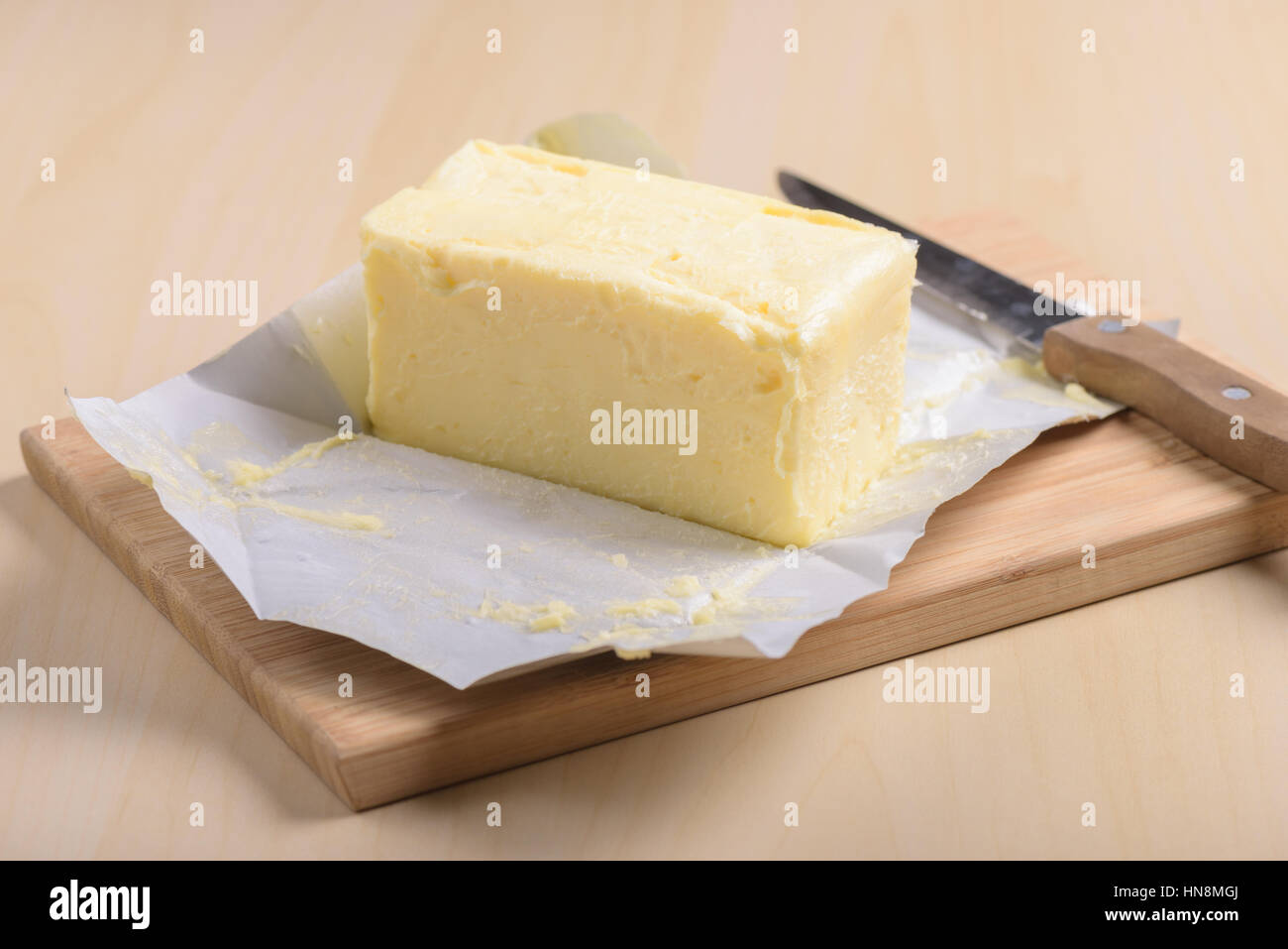 closeup creamy butter in its unwrapped foil paper Stock Photo - Alamy