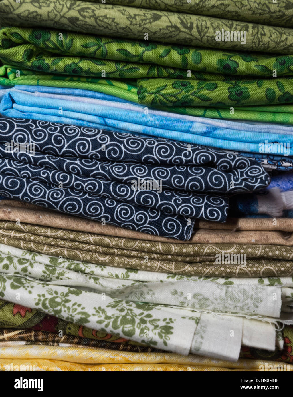Stack of Folded Fabrics with blue spiral pattern in the middle Stock ...