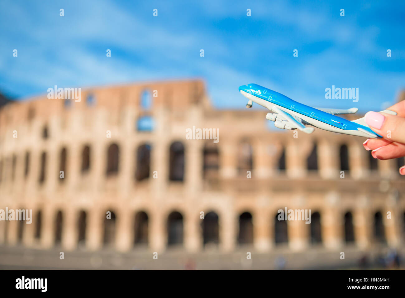 Closeup model airplane on Colosseum background. Italian european ...