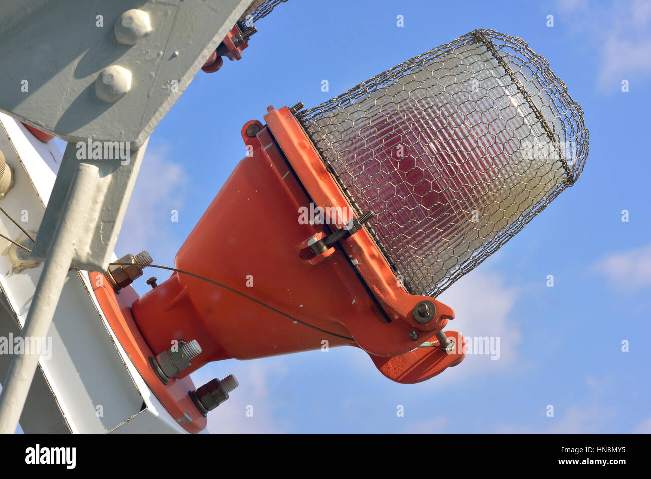 red flashing warning light against blue sky Stock Photo - Alamy