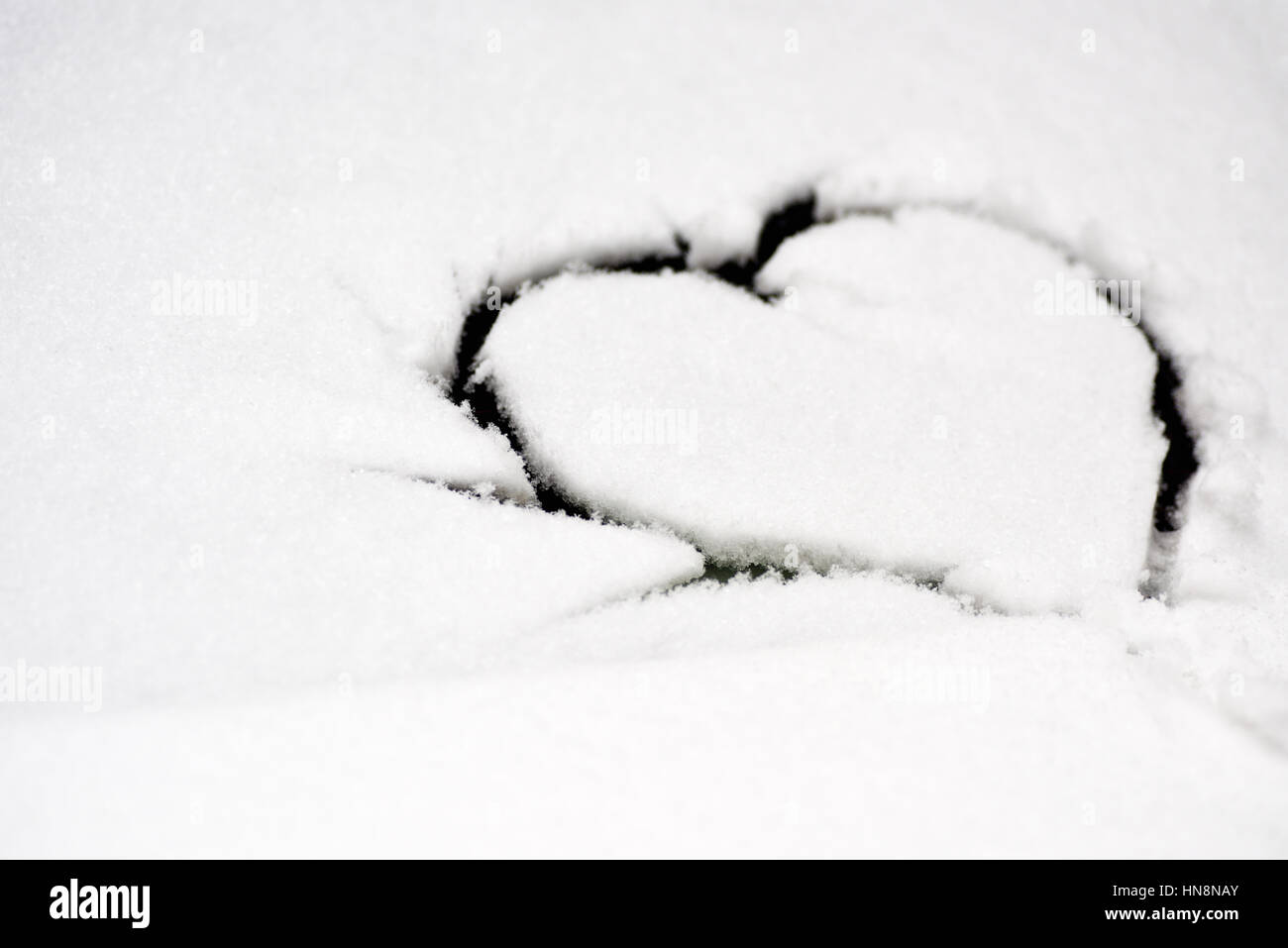 Shape of heart on snow Stock Photo - Alamy