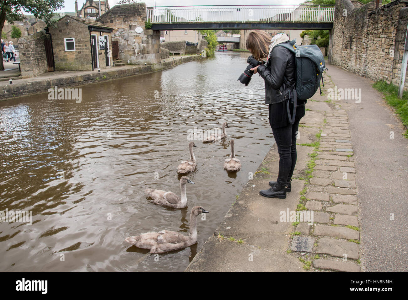 England, Yorkshire, Skipton - A young female tourist taking pictures ...