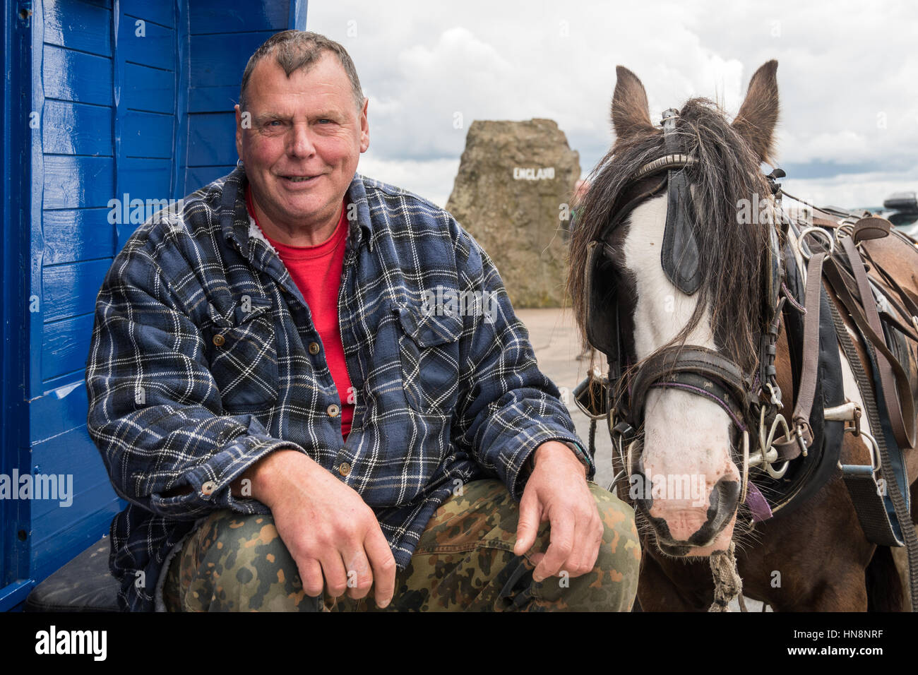 UK, Scotland, Scottish Borders - A man posed next to his gypsy caravan ...