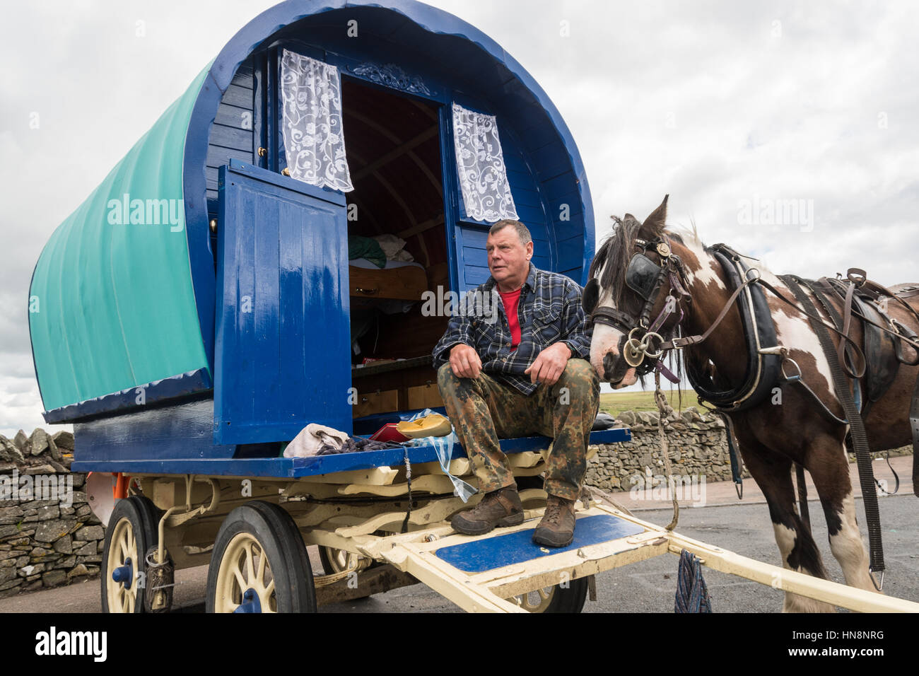 UK, Scotland, Scottish Borders - A man posed next to his gypsy caravan ...