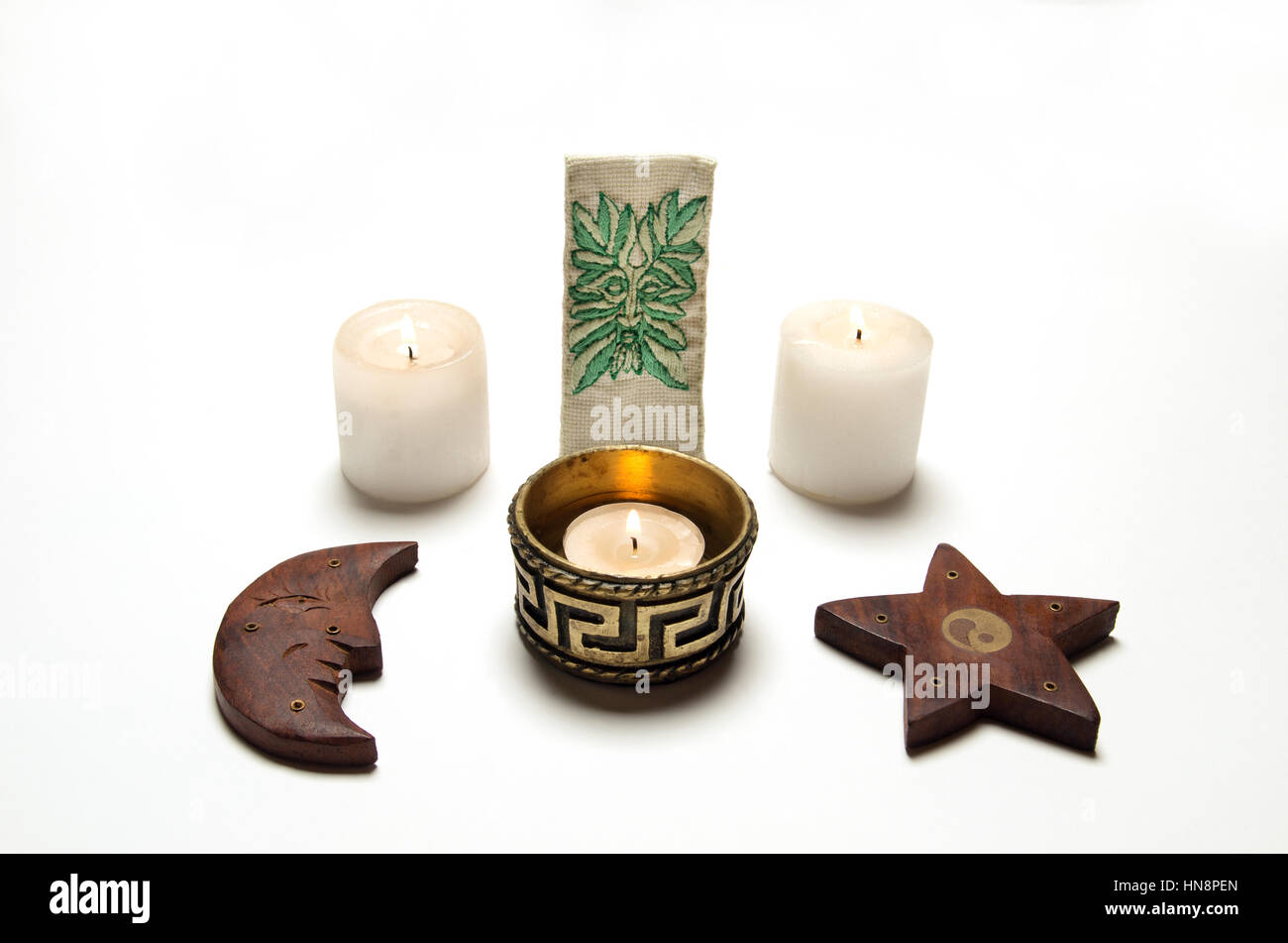 White wiccan altar with candles and green man embroidery Stock Photo ...