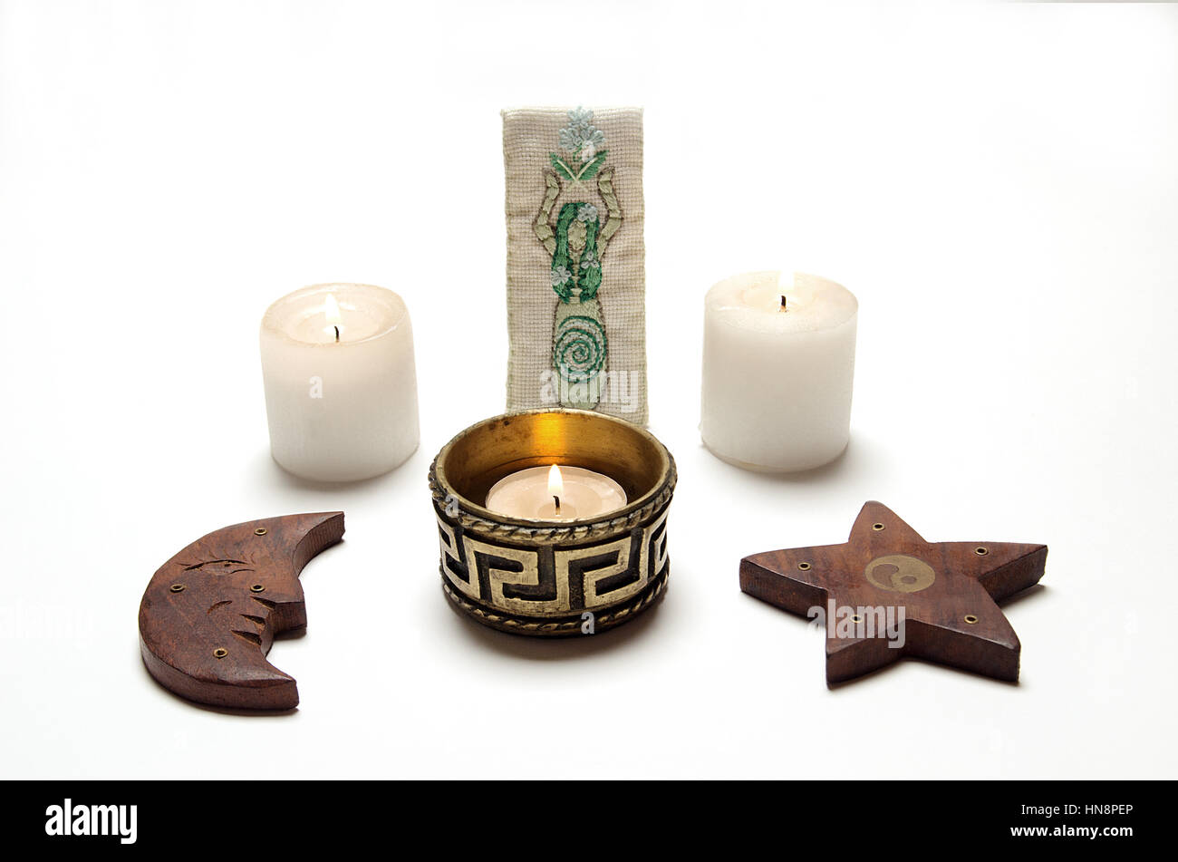 White wiccan altar with candles and green Goddess embroidery Stock ...