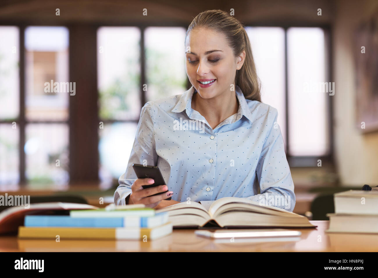 College student texting and reading hi-res stock photography and images ...