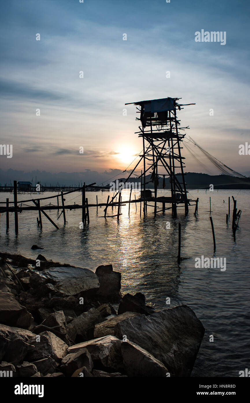 Fish traps and sunset Stock Photo - Alamy
