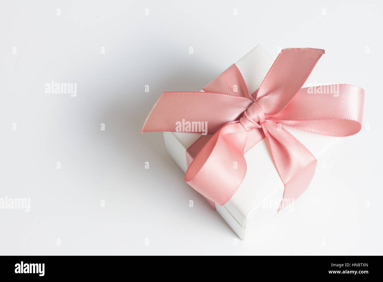 Box with pink ribbon Stock Photo - Alamy